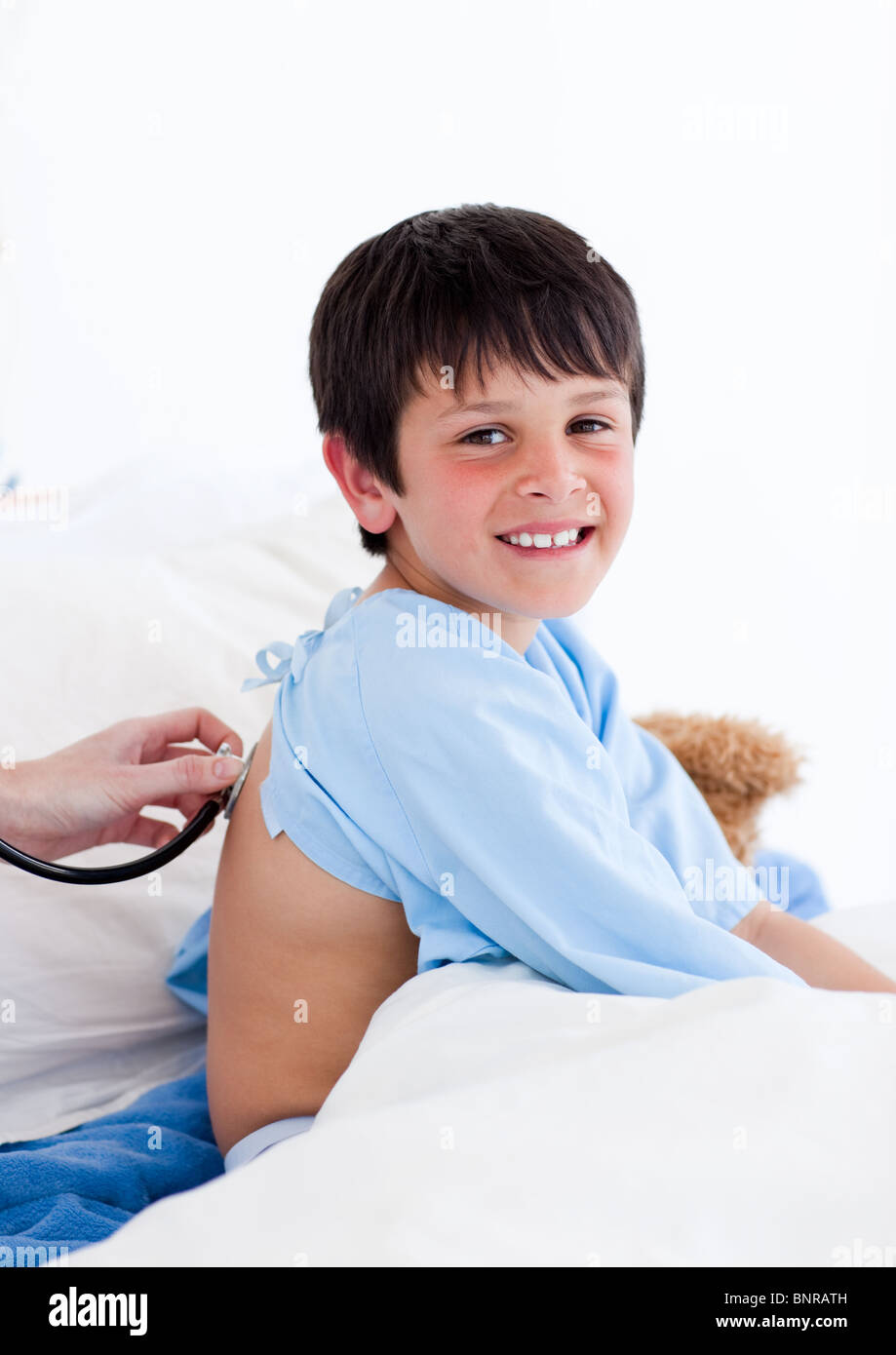 Portrait of a confident little boy examined by a doctor Stock Photo - Alamy