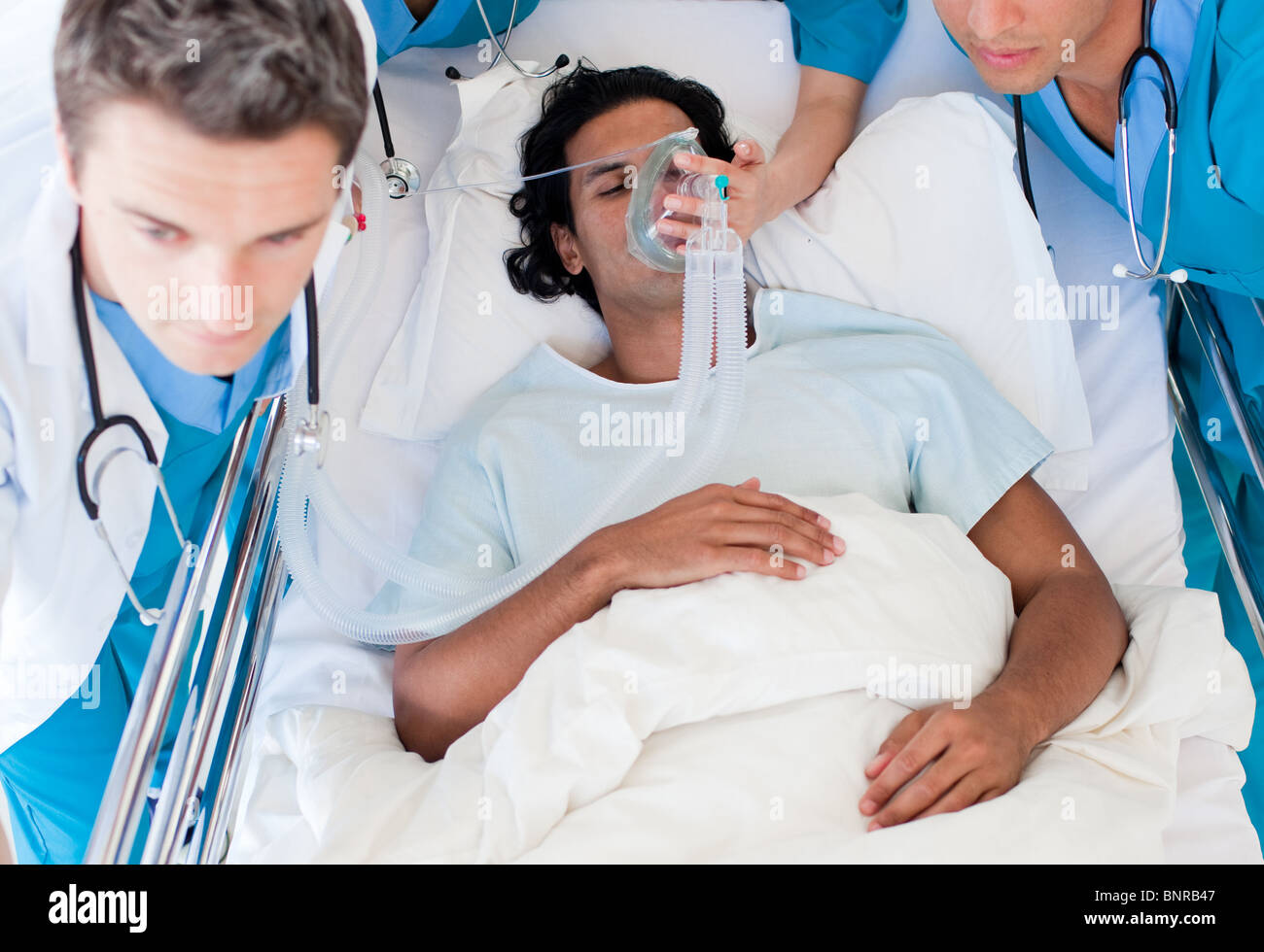 Doctors carrying a patient to intensive care unit Stock Photo - Alamy