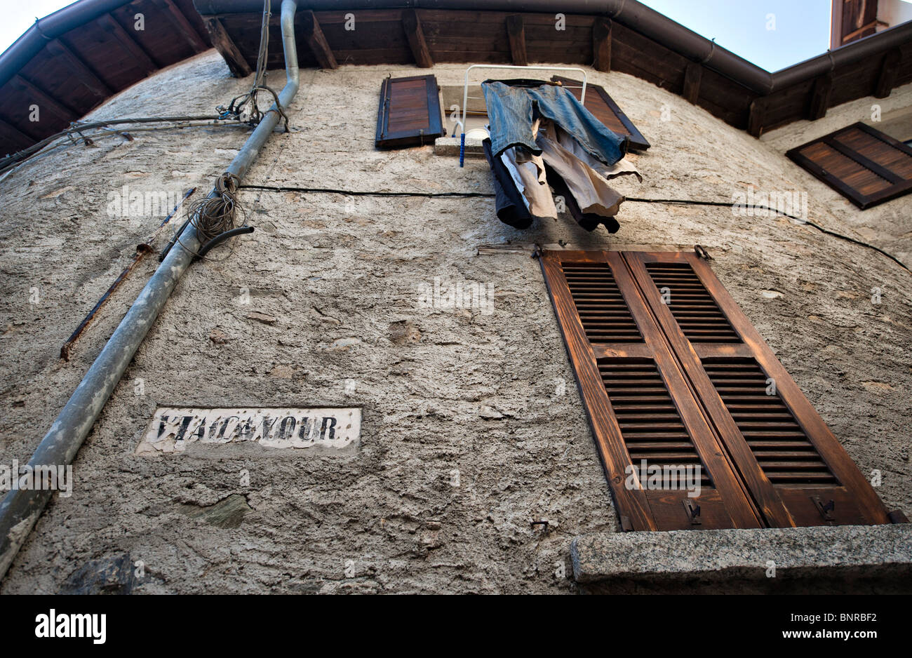 Clothes drying on a washing line outside window in an old building in ...