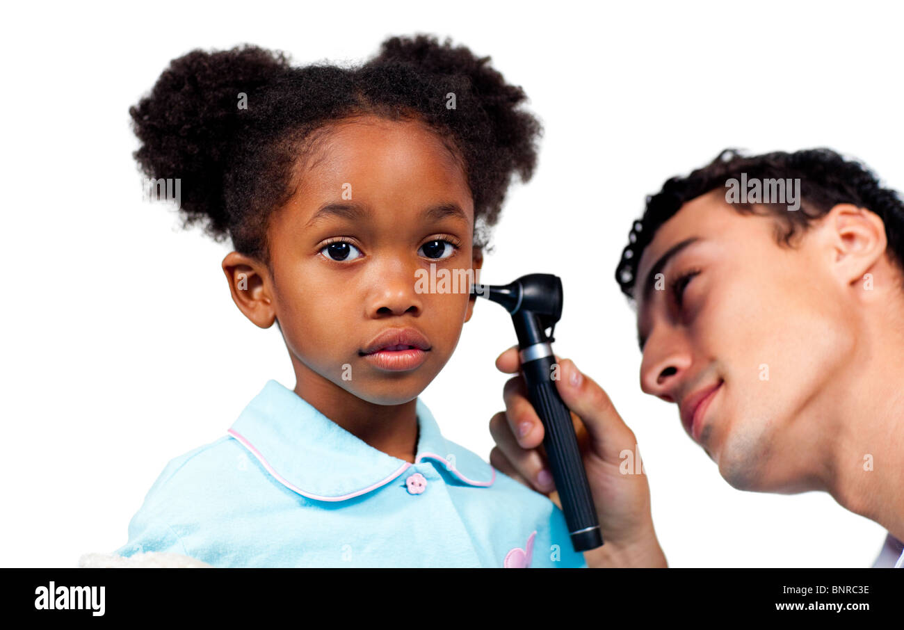 Concentrated doctor examining his young patient Stock Photo - Alamy