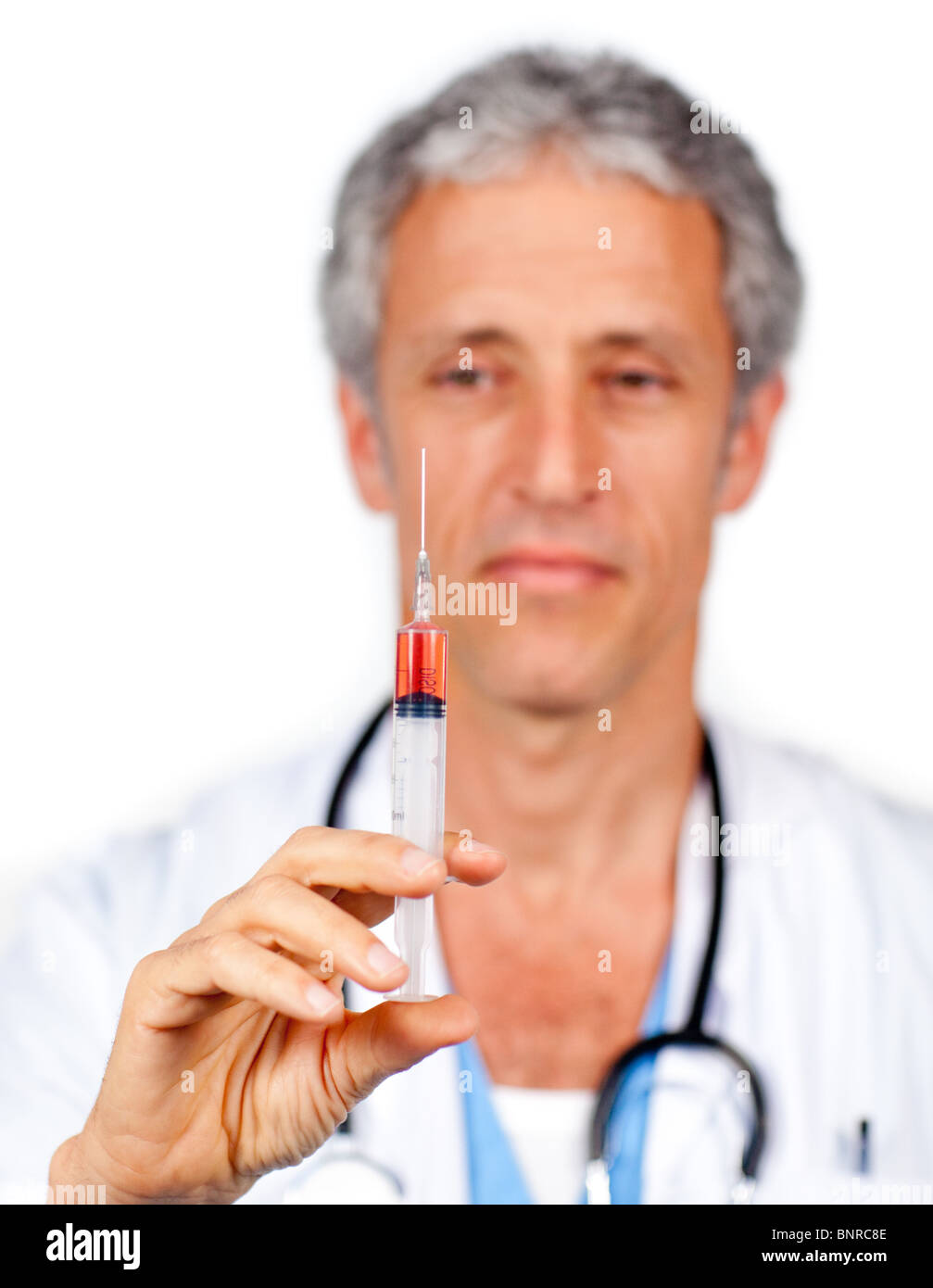 Self-assured doctor presenting a syringe Stock Photo - Alamy