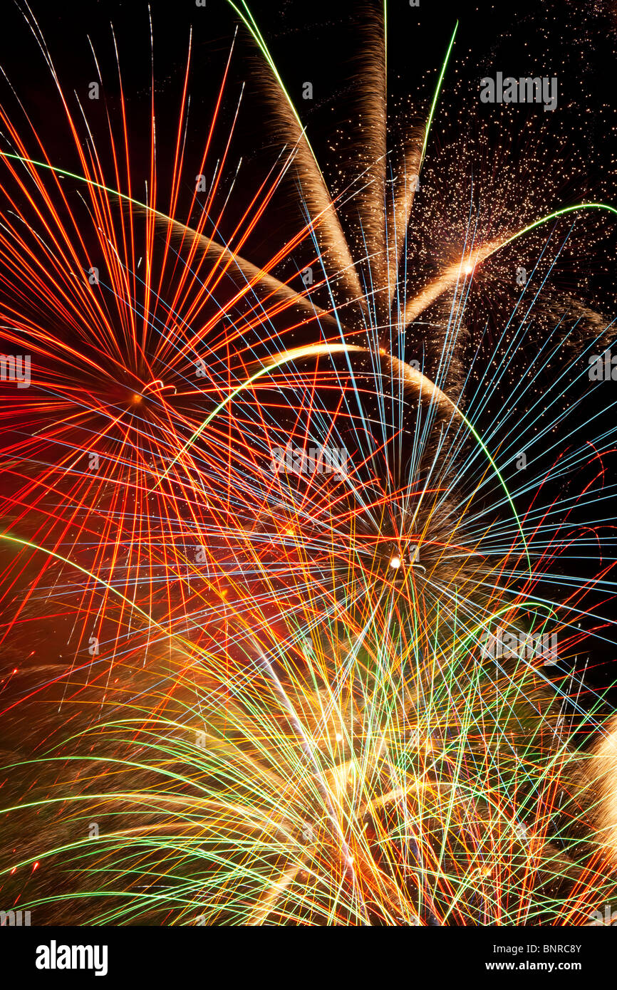Fireworks exploding in night sky, pyrotechnics Stock Photo - Alamy