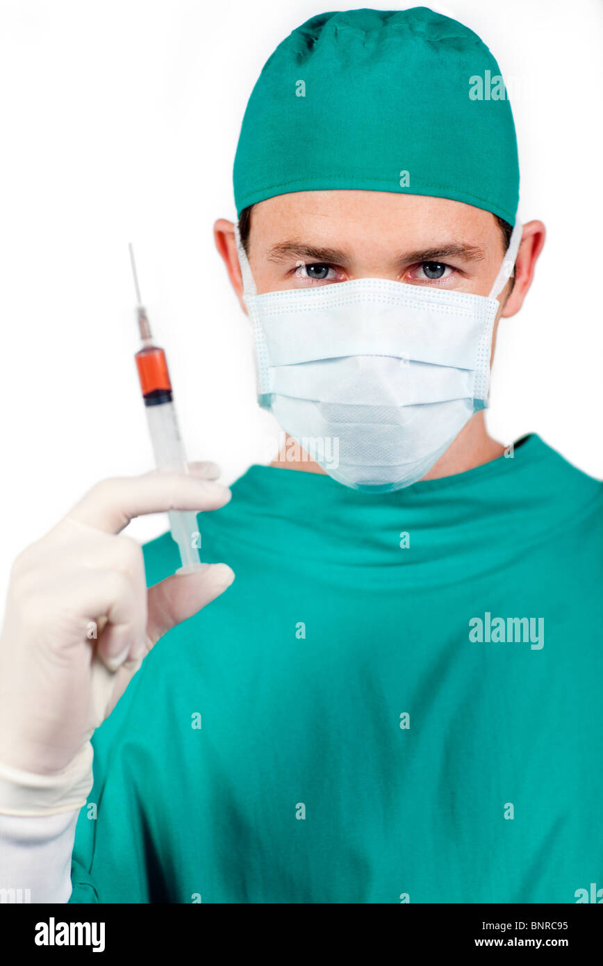 Masked surgeon holding a syringe Stock Photo - Alamy