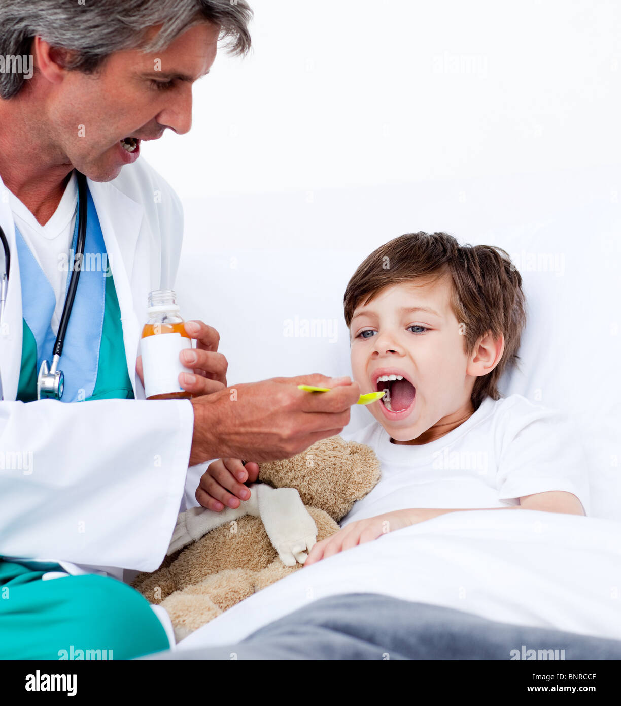 Child taking cough medicine Stock Photo - Alamy