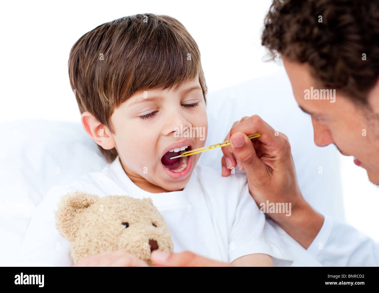 Doctor taking little boy's temperature Stock Photo - Alamy