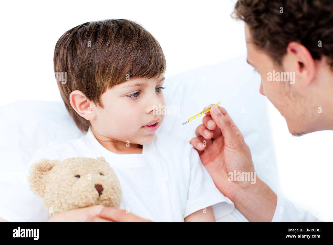 Doctor taking little boy's temperature Stock Photo - Alamy