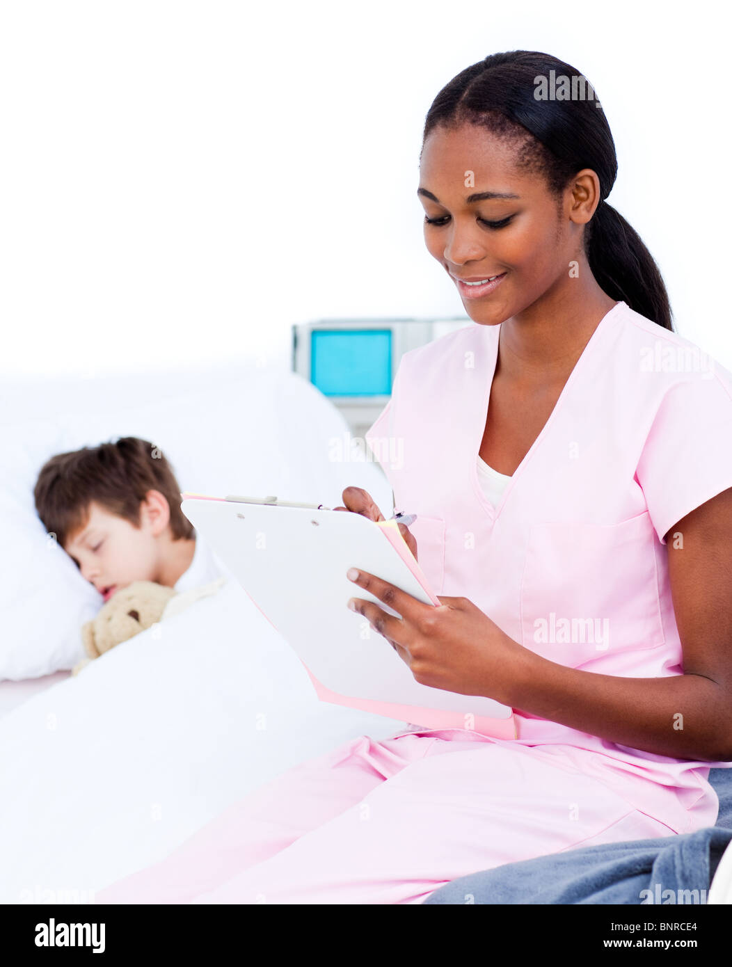 Doctor making notes on a patient's clipboard Stock Photo - Alamy