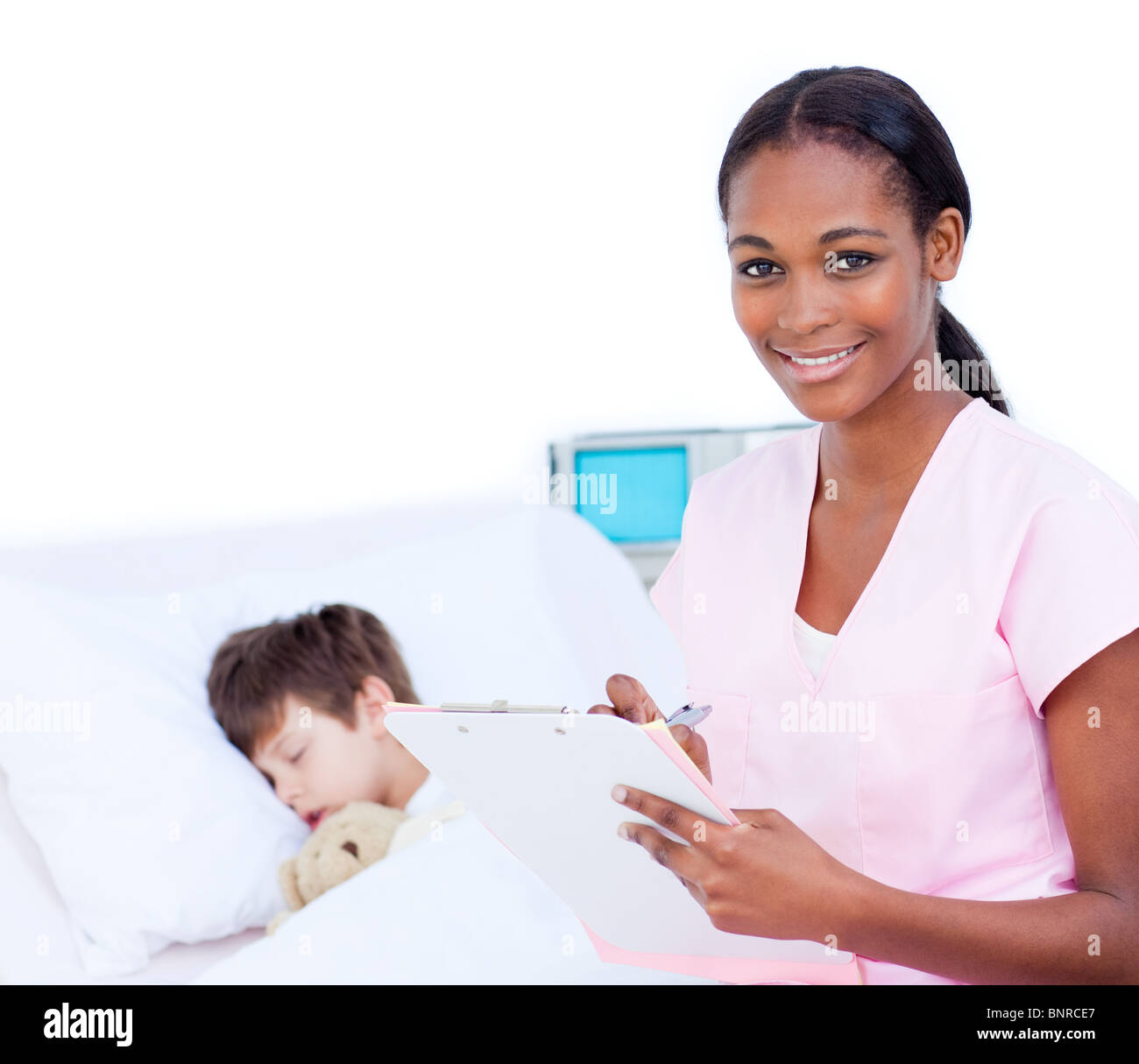 Confident doctor making notes on a patient's clipboard Stock Photo - Alamy