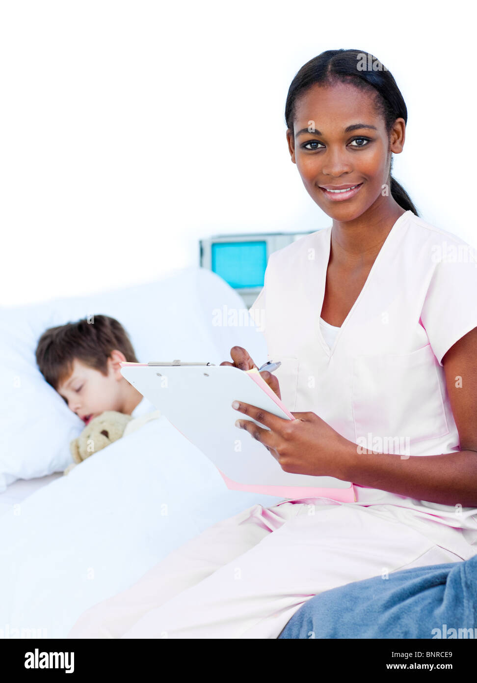 Charismatic doctor making notes on a patient's clipboard Stock Photo ...