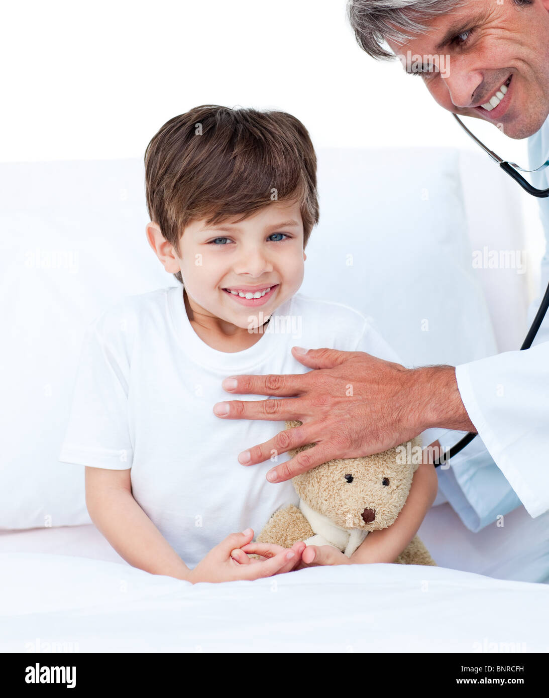 Smiling little boy attending a medical check-up Stock Photo - Alamy