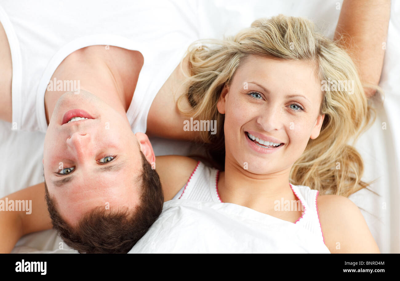 Happy couple resting in bed Stock Photo - Alamy