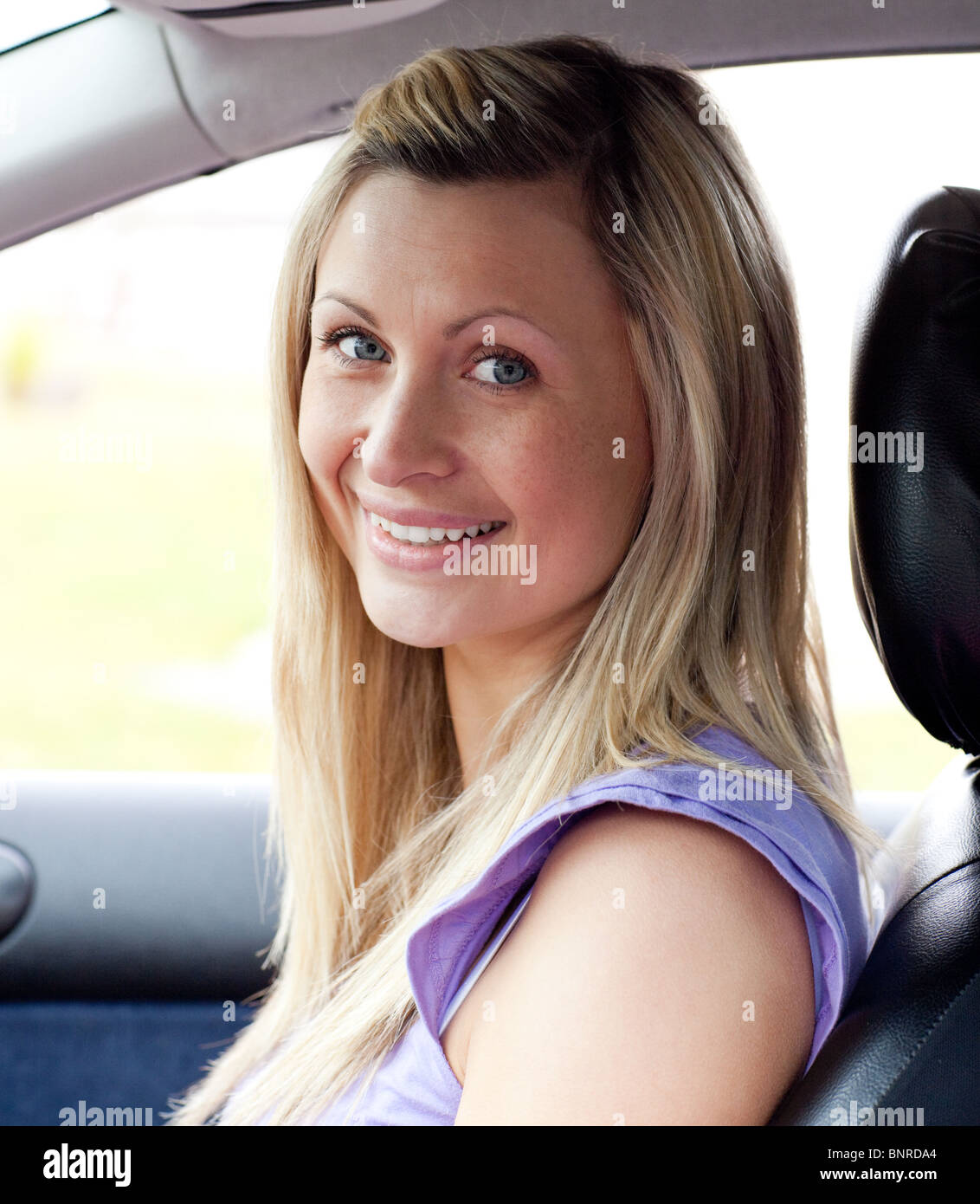 Portrait of a smiling young female driver Stock Photo - Alamy