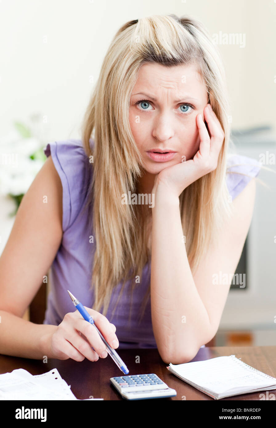 Upset woman paying her bills Stock Photo - Alamy