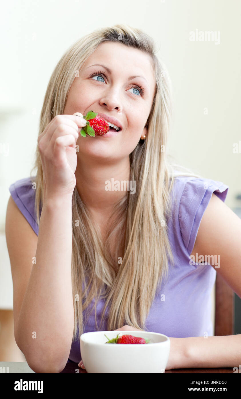 Portrait of a beautiful woman eating a strawberry Stock Photo - Alamy