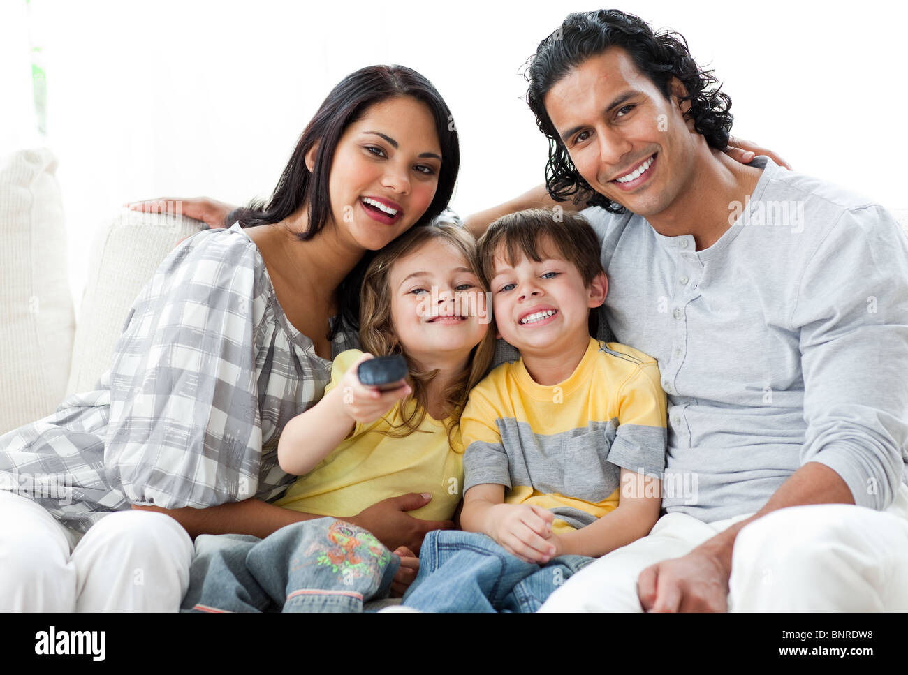 Lively family watching TV together Stock Photo - Alamy