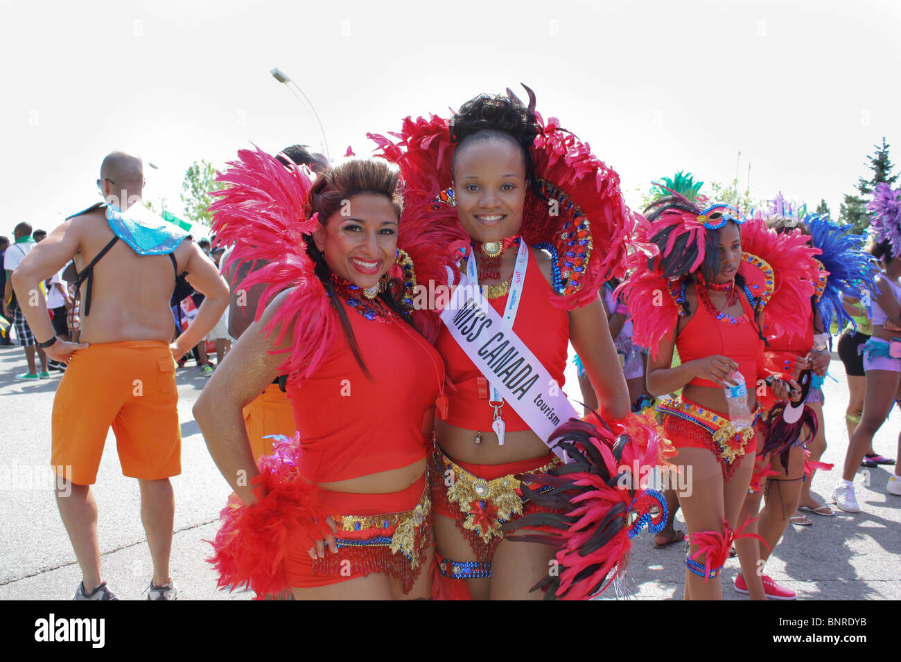 two happy smile black women costume feather parade Stock Photo - Alamy