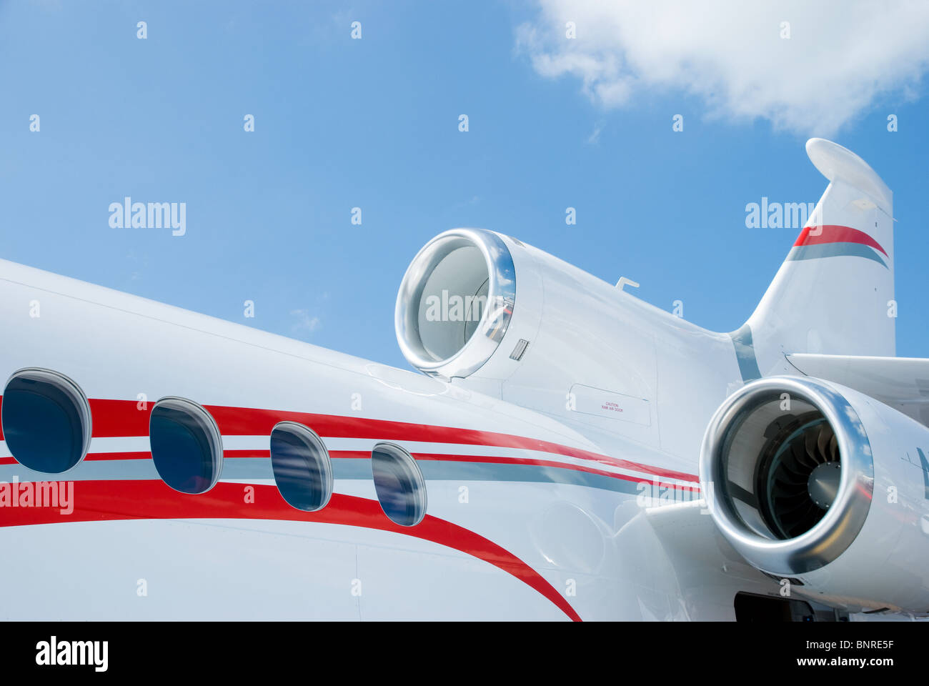 Rear detail of white and red, three engined corporate jet Stock Photo ...
