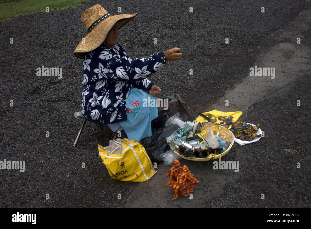 A woman sells souvenirs in the ancient Toltec city of Teotihuacan ...