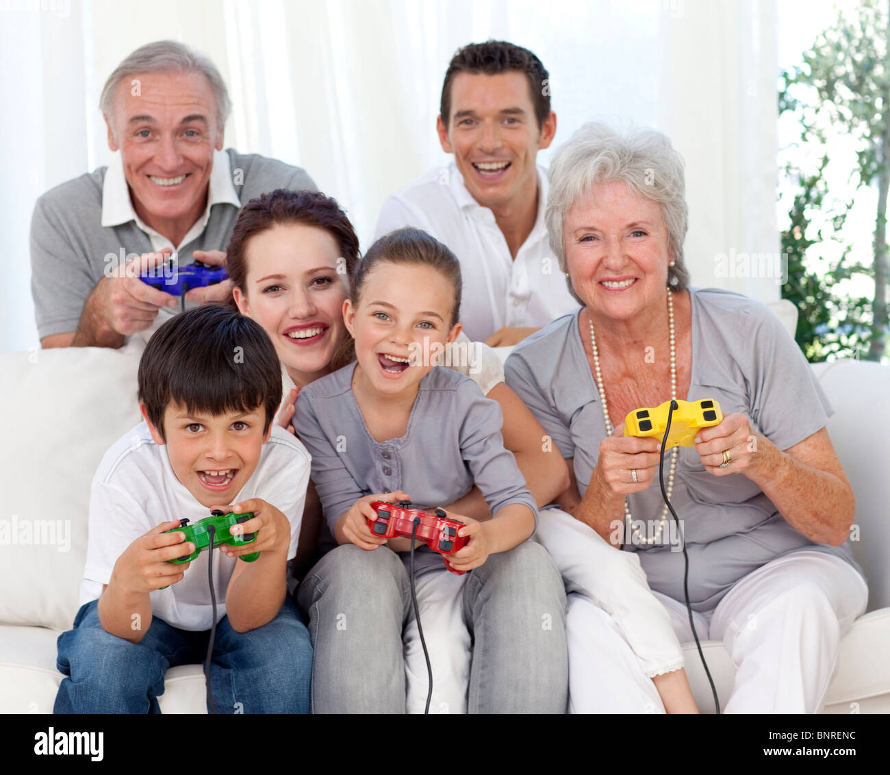 Family having fun playing video games Stock Photo - Alamy