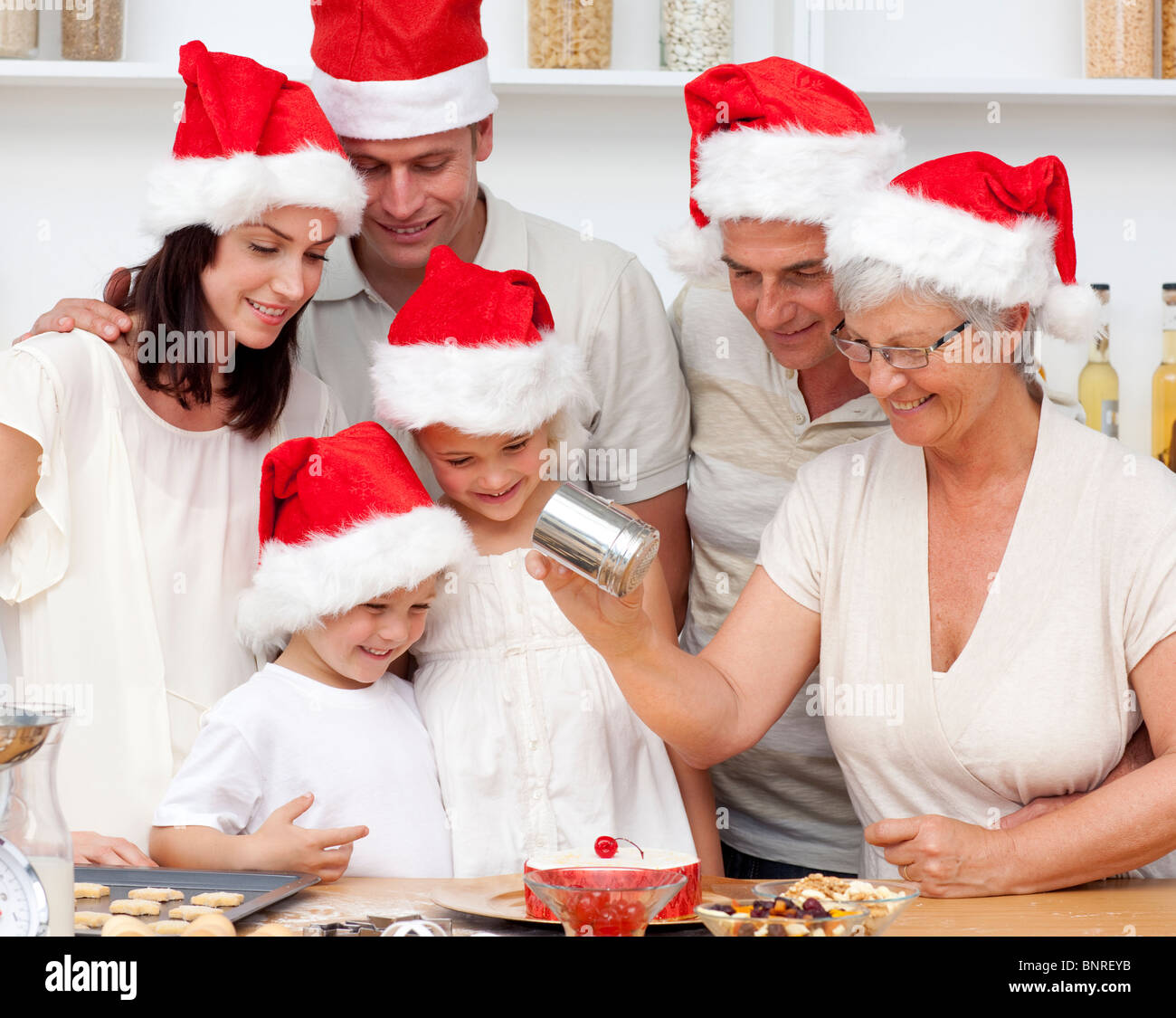 Happy family baking Christmas cakes Stock Photo - Alamy