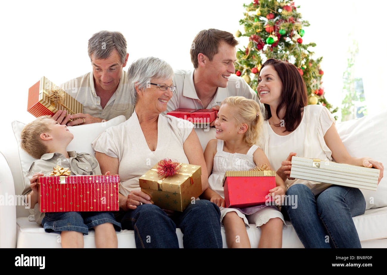 Family giving presents for Christmas Stock Photo - Alamy