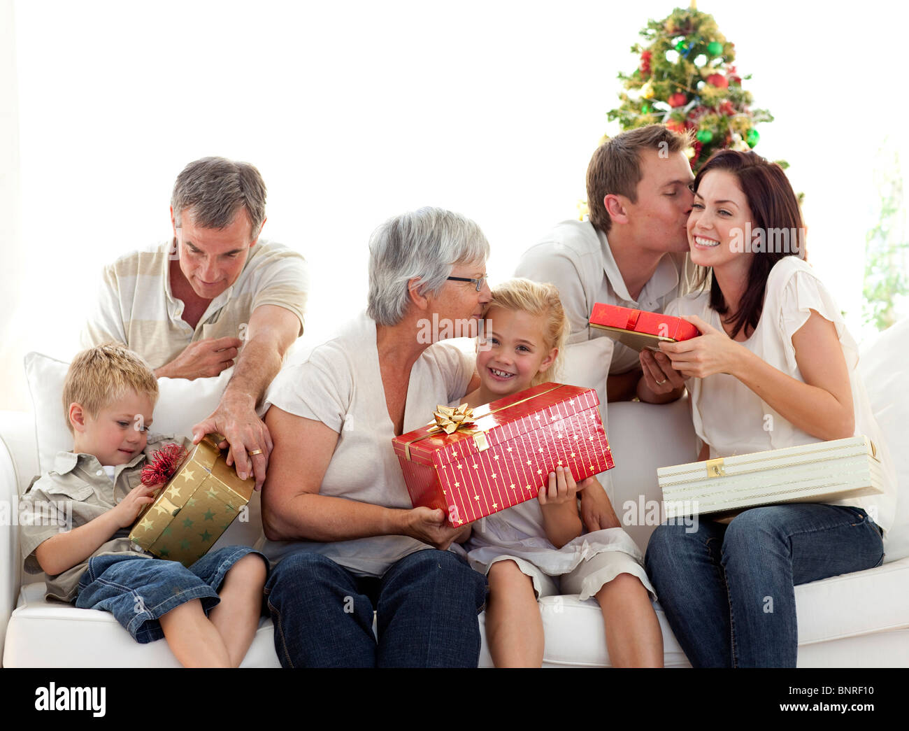 Family giving presents for Christmas Stock Photo - Alamy