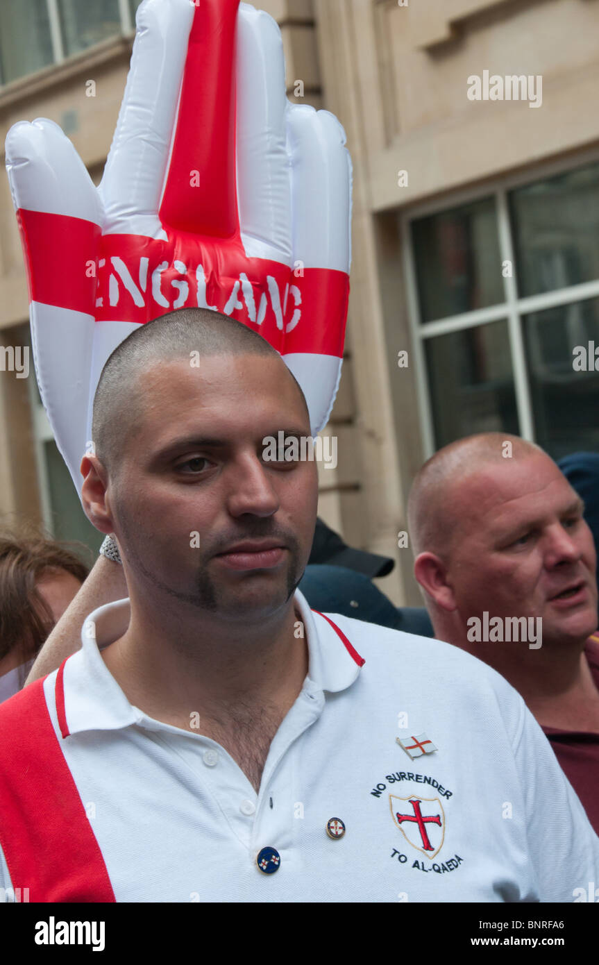 Man in 'No Surrender to Al-Qaeda' shirt and large 'England' hand at ...