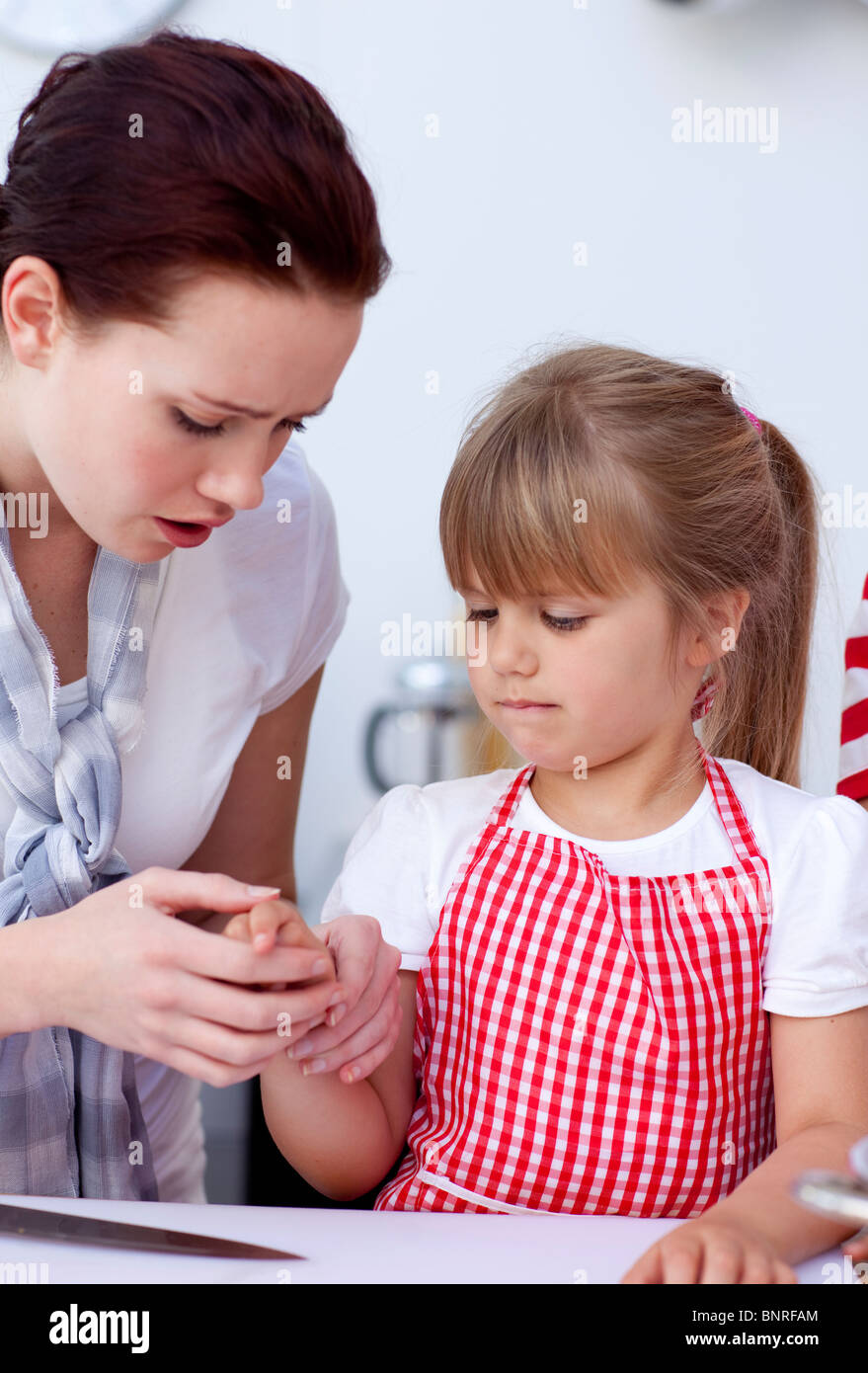 Little girl injured by a knife in kitchen Stock Photo - Alamy