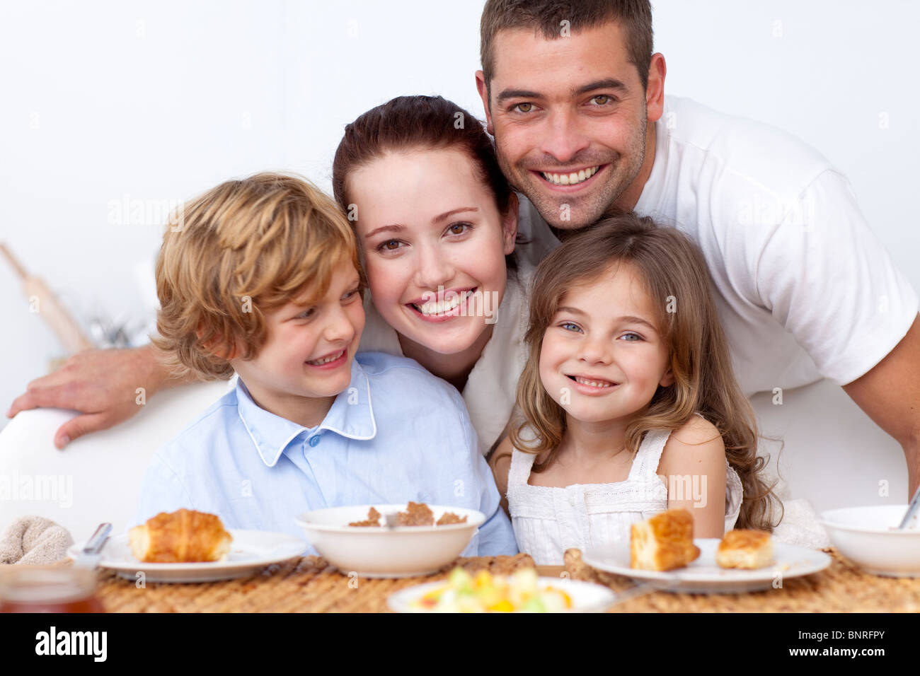 Happy family having breakfast Stock Photo - Alamy