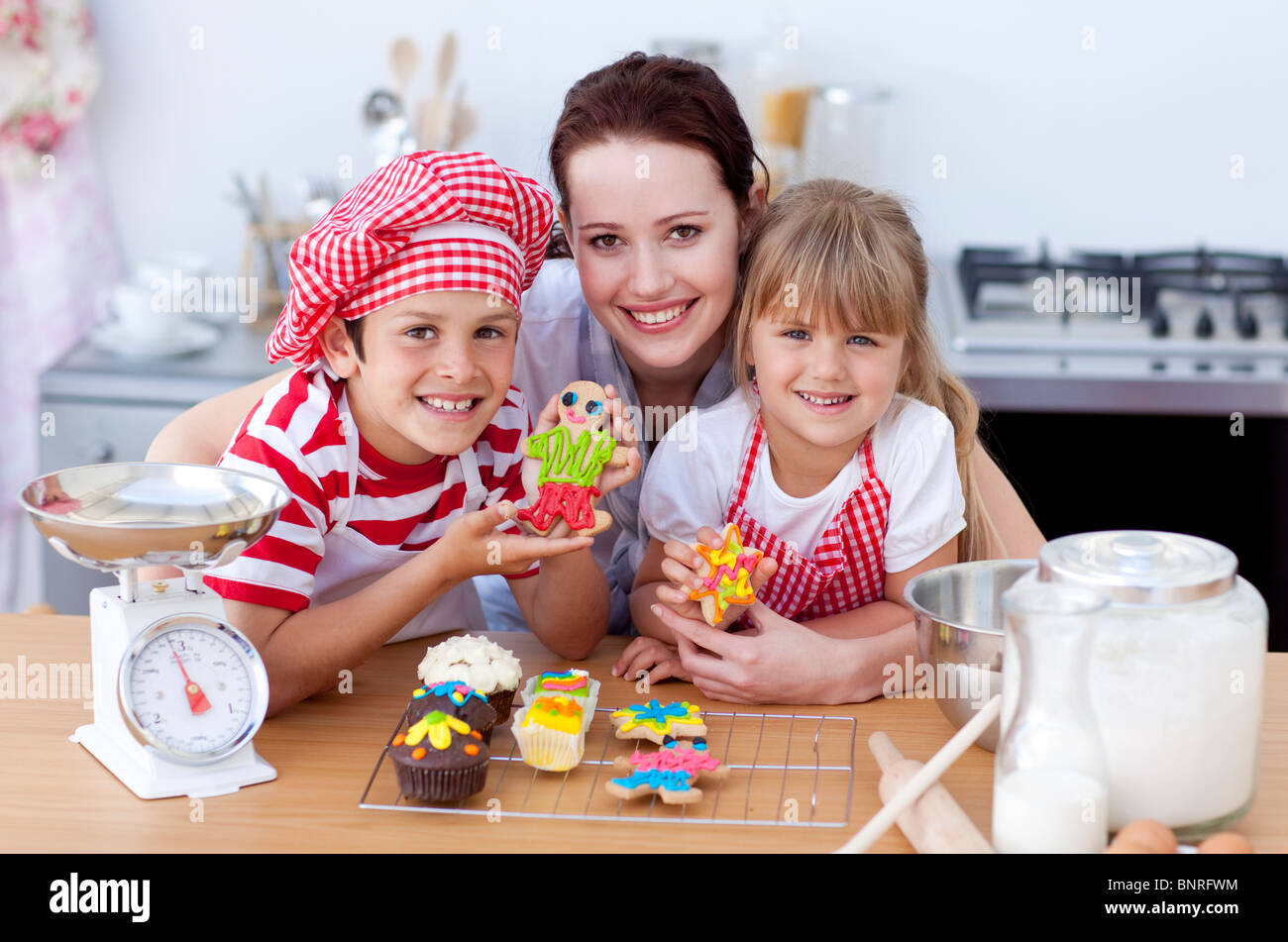 Mother baking with children in the kitchen Stock Photo - Alamy