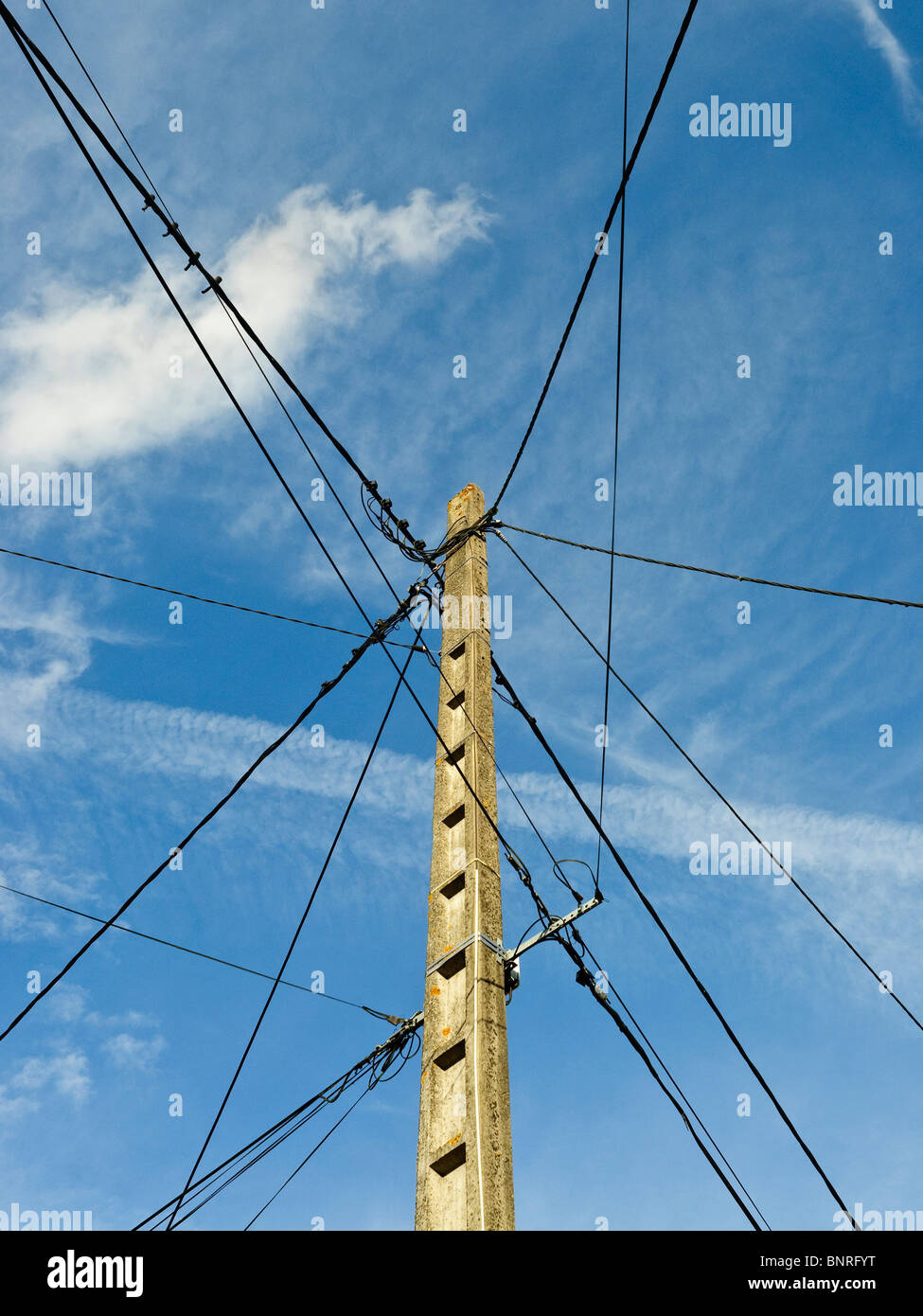 Old concrete post with multiple telephone wires - France Stock Photo ...