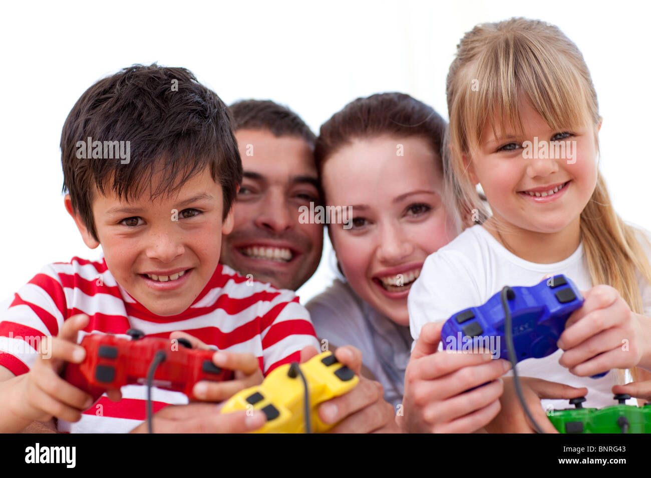 Portrait of family playing video games at home Stock Photo - Alamy