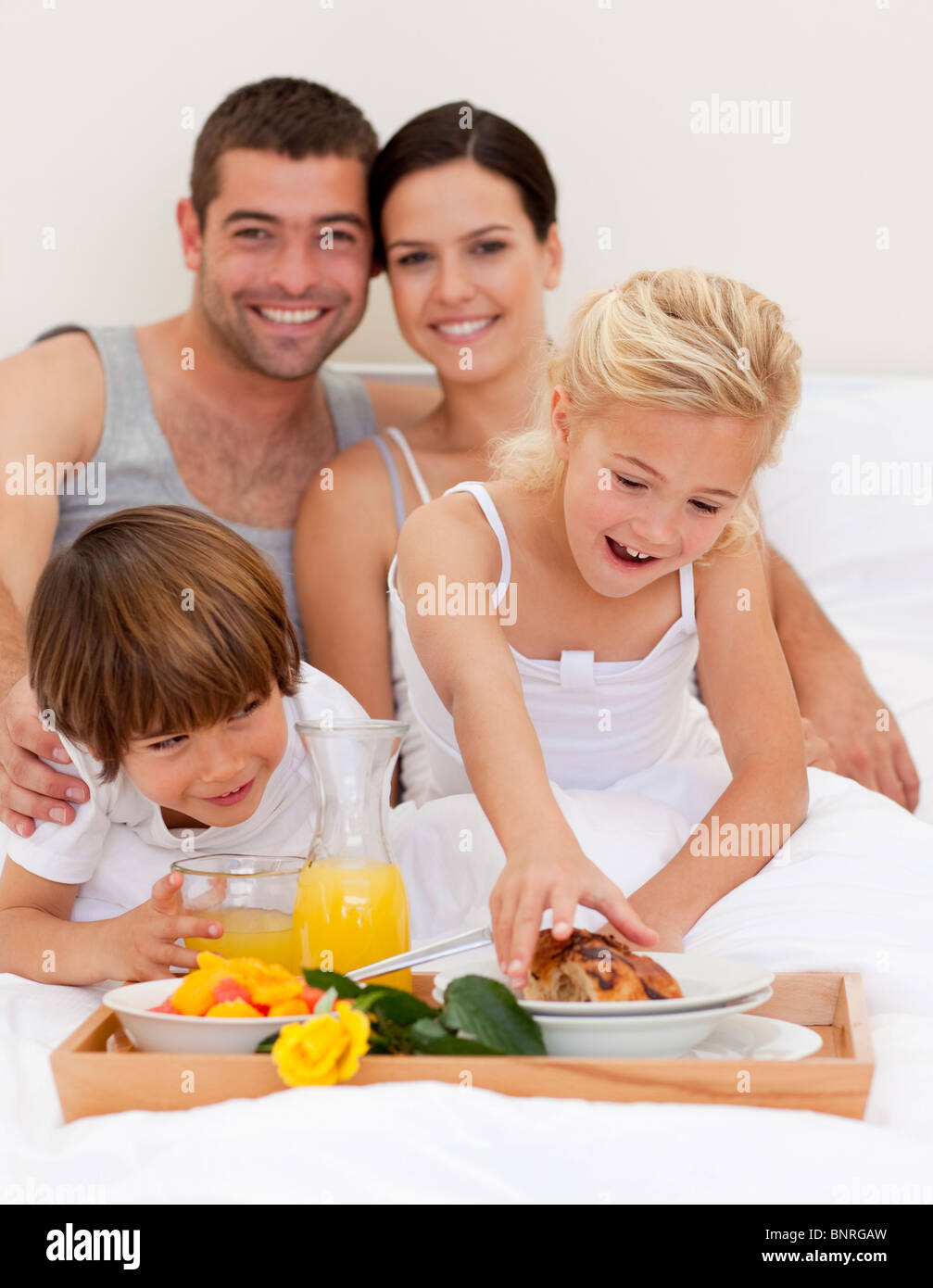 Family eating breakfast in bedroom Stock Photo - Alamy