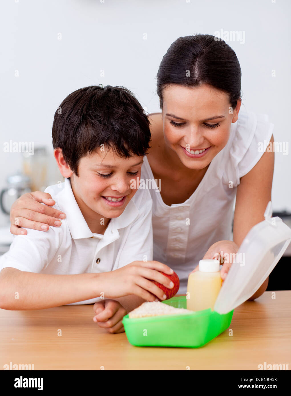Mother and son making the school lunch Stock Photo - Alamy