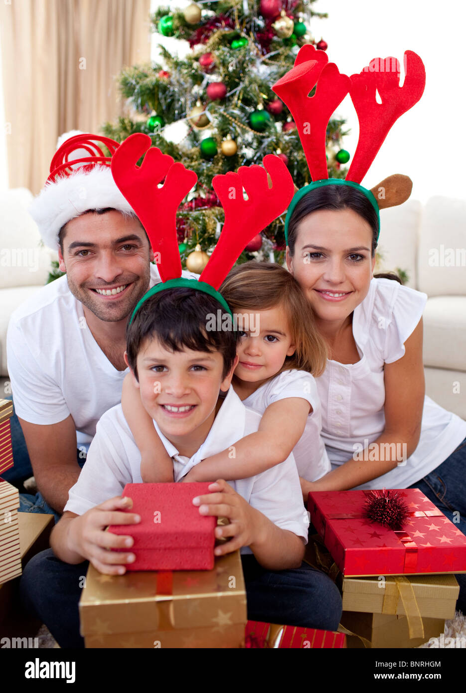 Lovely family giving presents for Christmas Stock Photo - Alamy