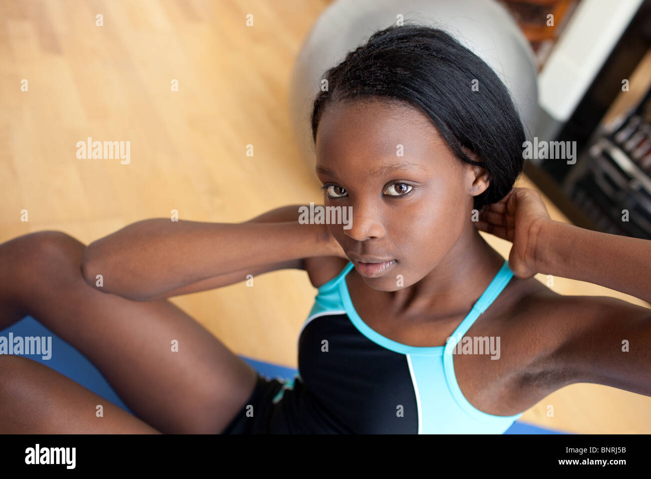 Black woman doing sit ups in the gym hi-res stock photography and ...