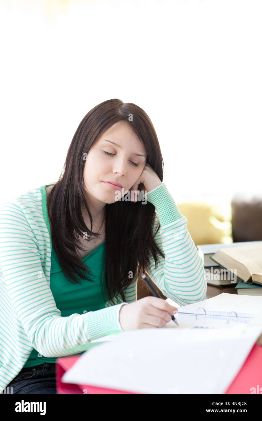 Tired young student sleeping while doing her homework Stock Photo - Alamy