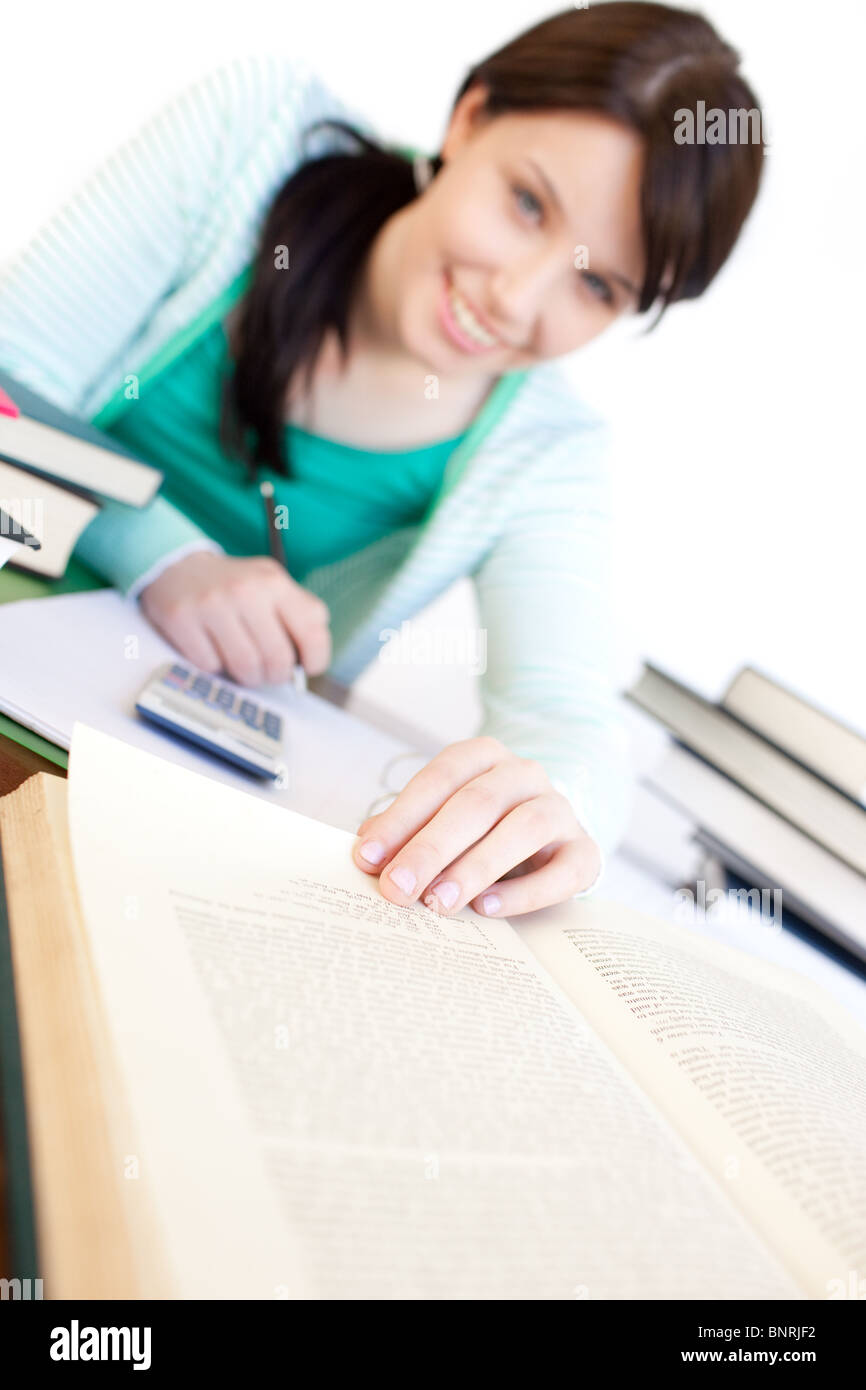 Positive student doing her homework on a desk Stock Photo - Alamy