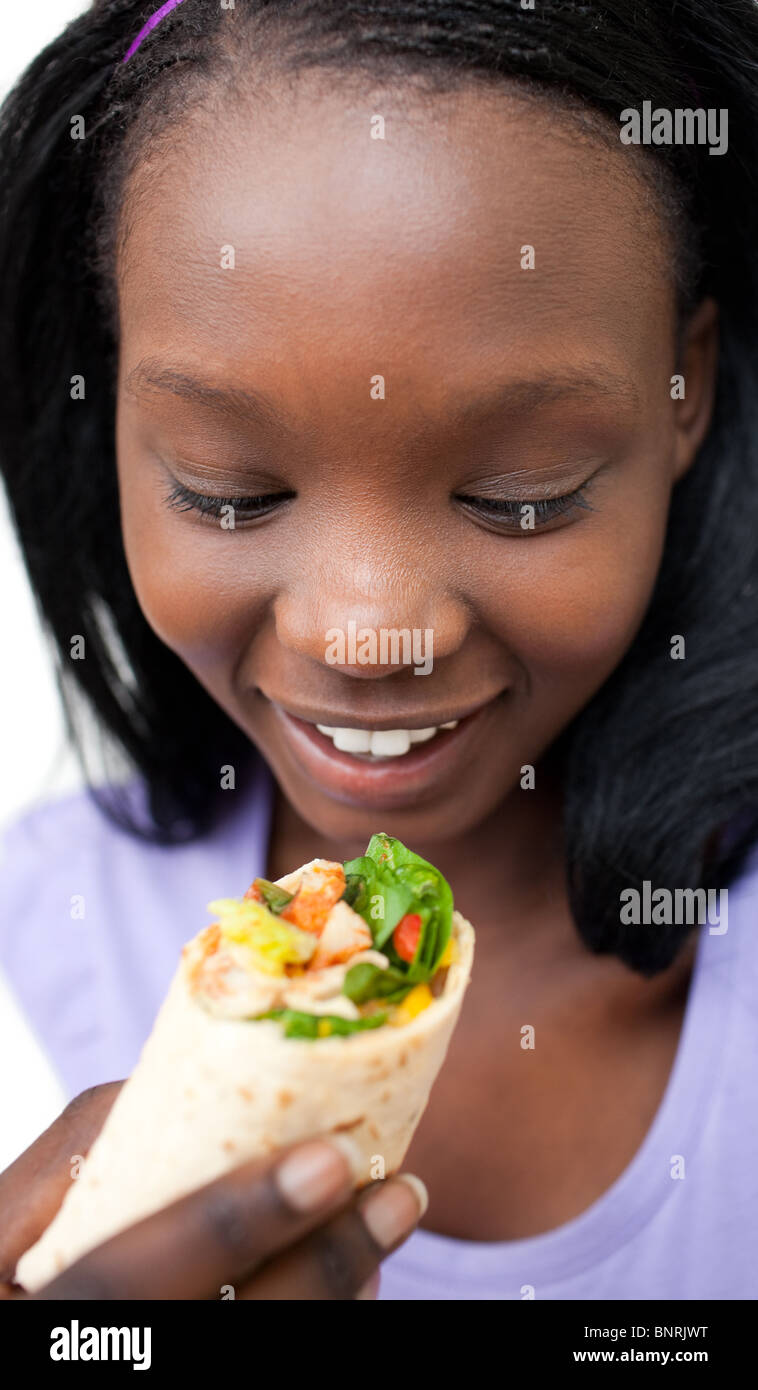 Delighted woman eating a wrap Stock Photo - Alamy