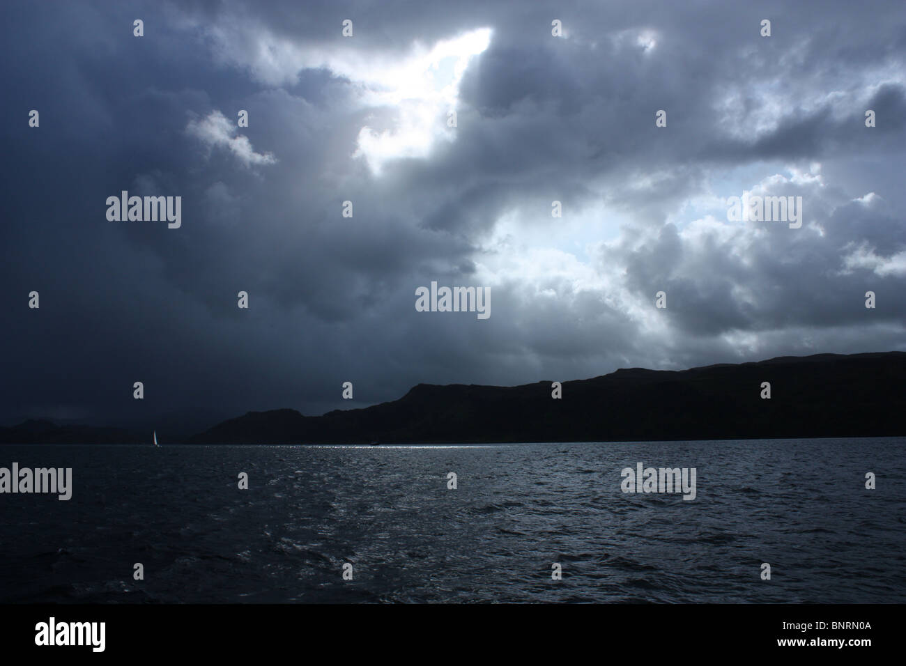 Yacht sailing through Storm Sky Stock Photo - Alamy