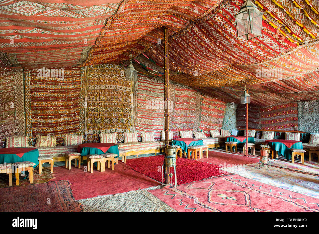 The interior of a Berber carpeted tent used as a restaurant, in ...
