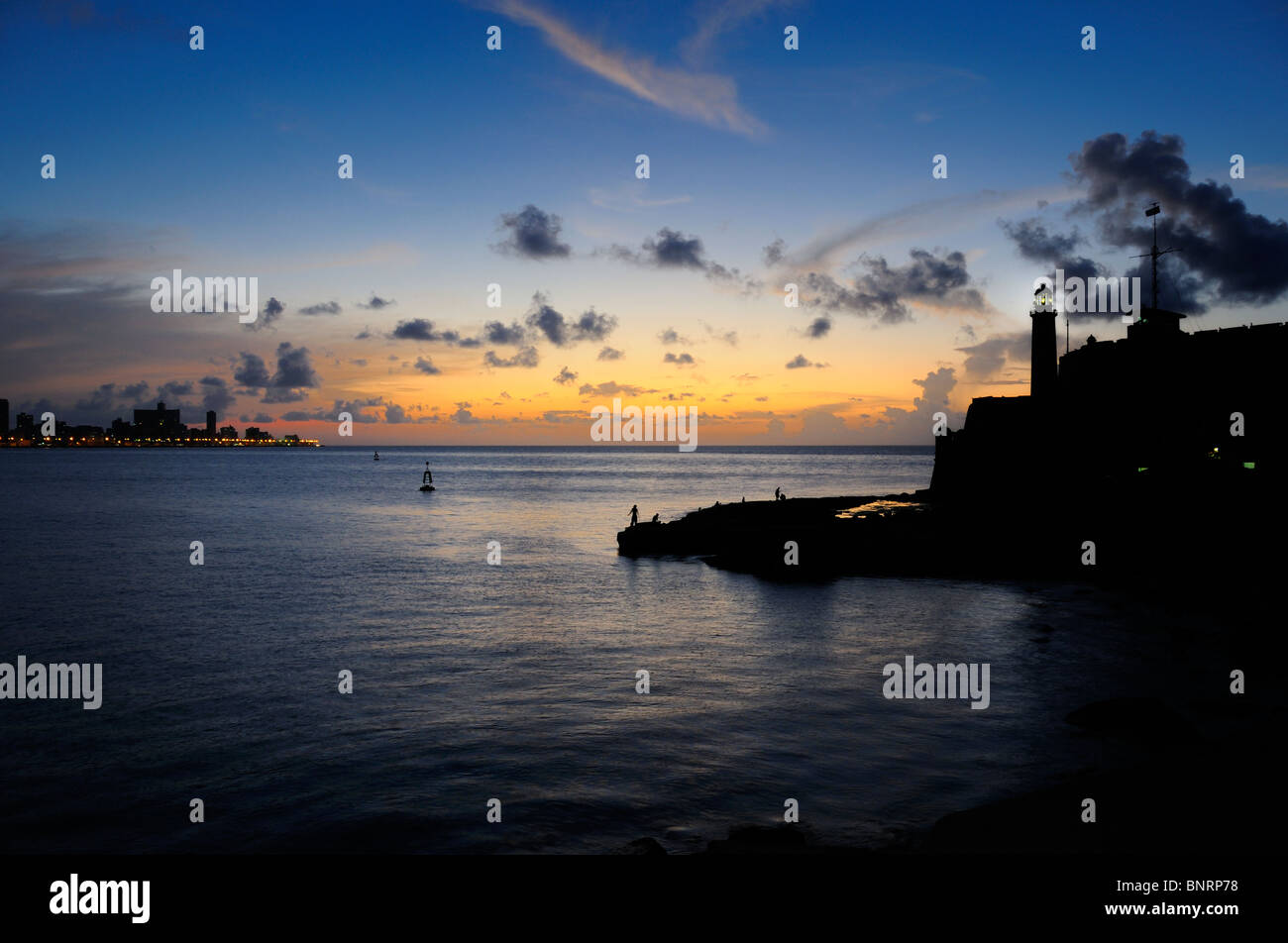 Silhouette of "el Morro" fortress against sunset background Stock Photo ...