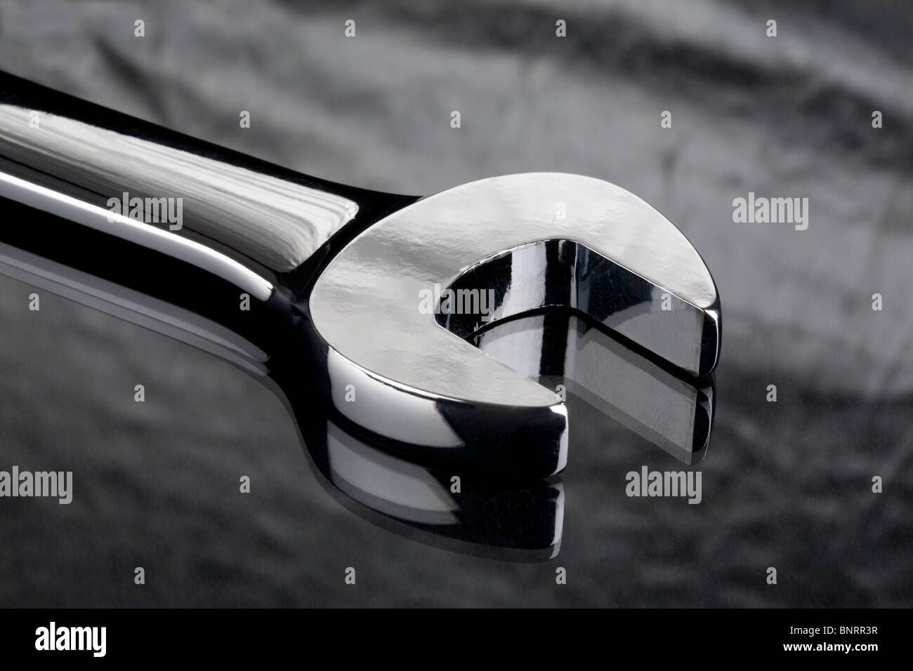 A spanner on a reflective background Stock Photo - Alamy