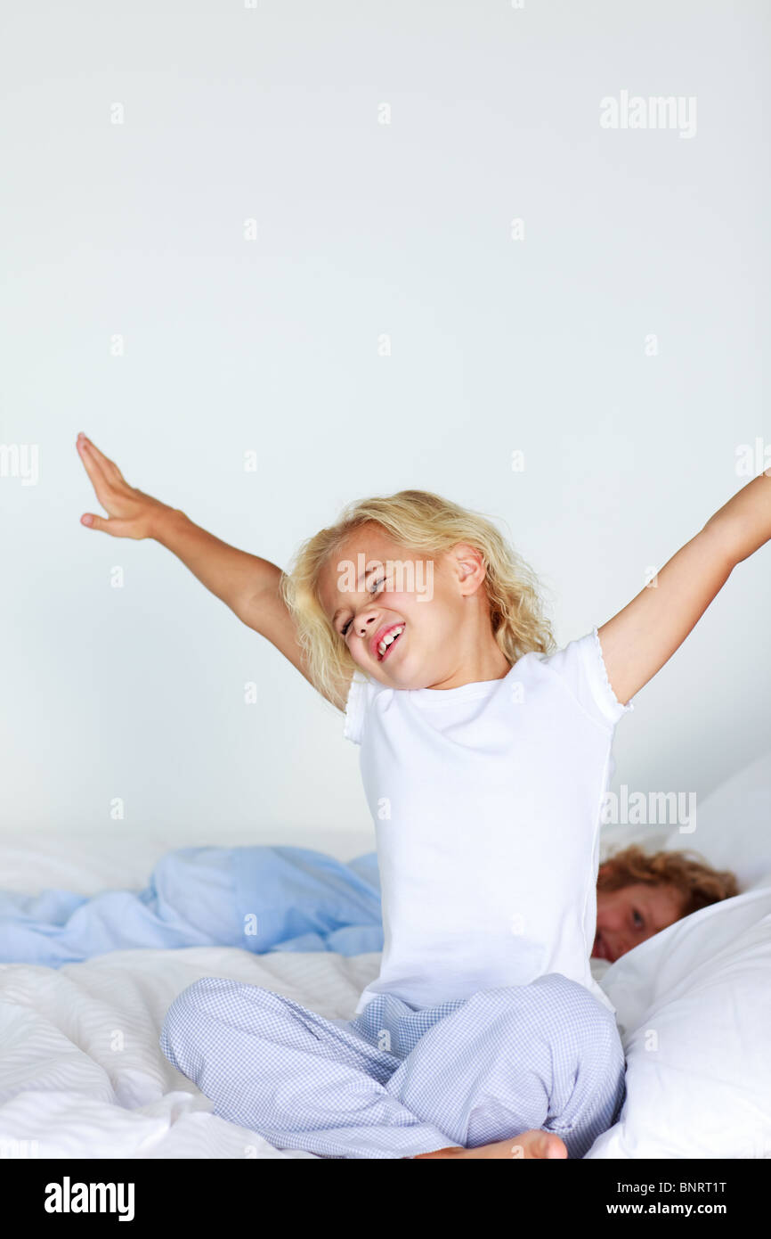 Little girl stretching in bed Stock Photo - Alamy