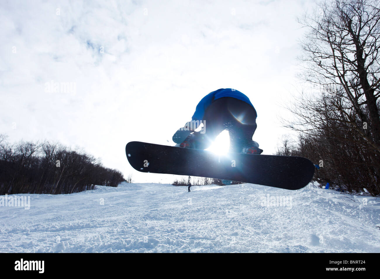 A female snowboarder takes air in New Hampshire Stock Photo - Alamy
