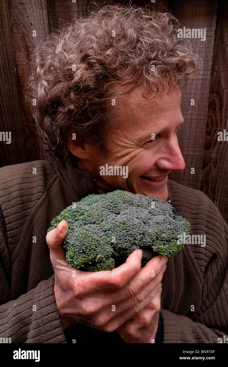 Europe, man holding broccoli Stock Photo - Alamy