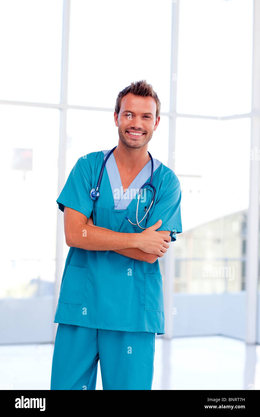 Smiling handsome doctor isolated in hospital Stock Photo - Alamy