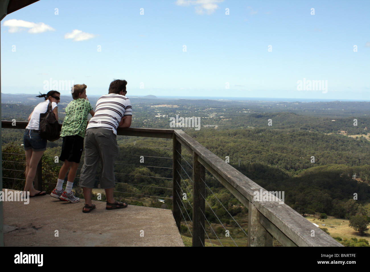 Three people looking out over Queensland landscape Australia Stock ...