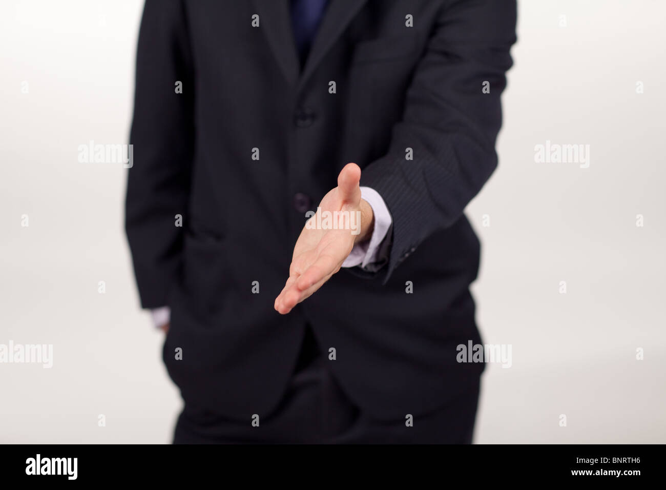 businessman showing a handshake to the camera Stock Photo - Alamy