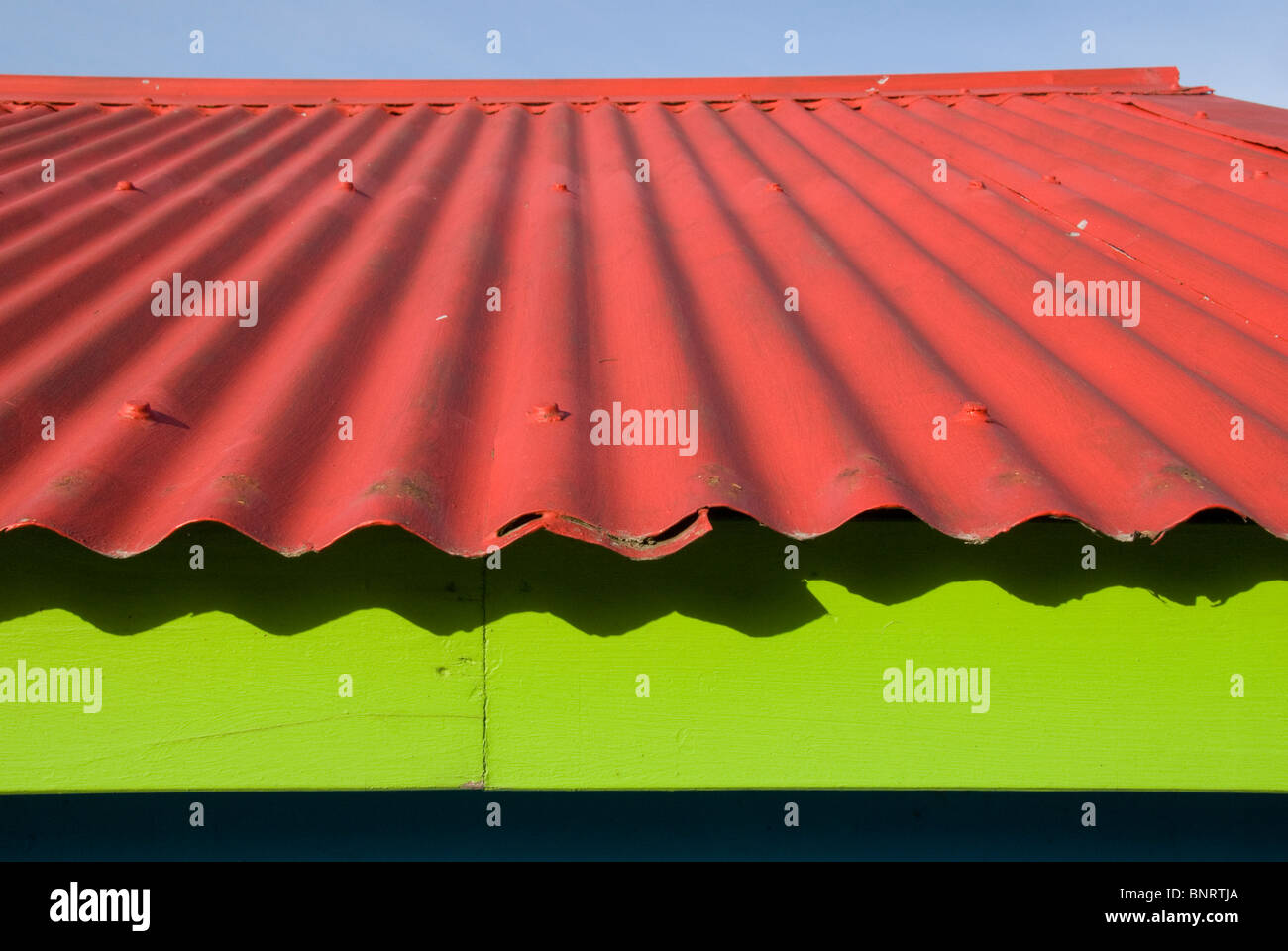 Red corrugated iron roof, green fascia and blue sky, Eastbourne ...